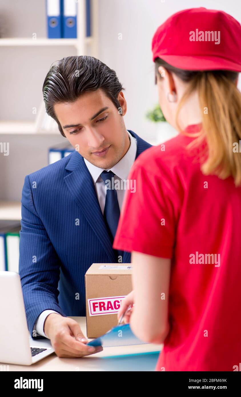 The courier delivering parcel to the office Stock Photo - Alamy