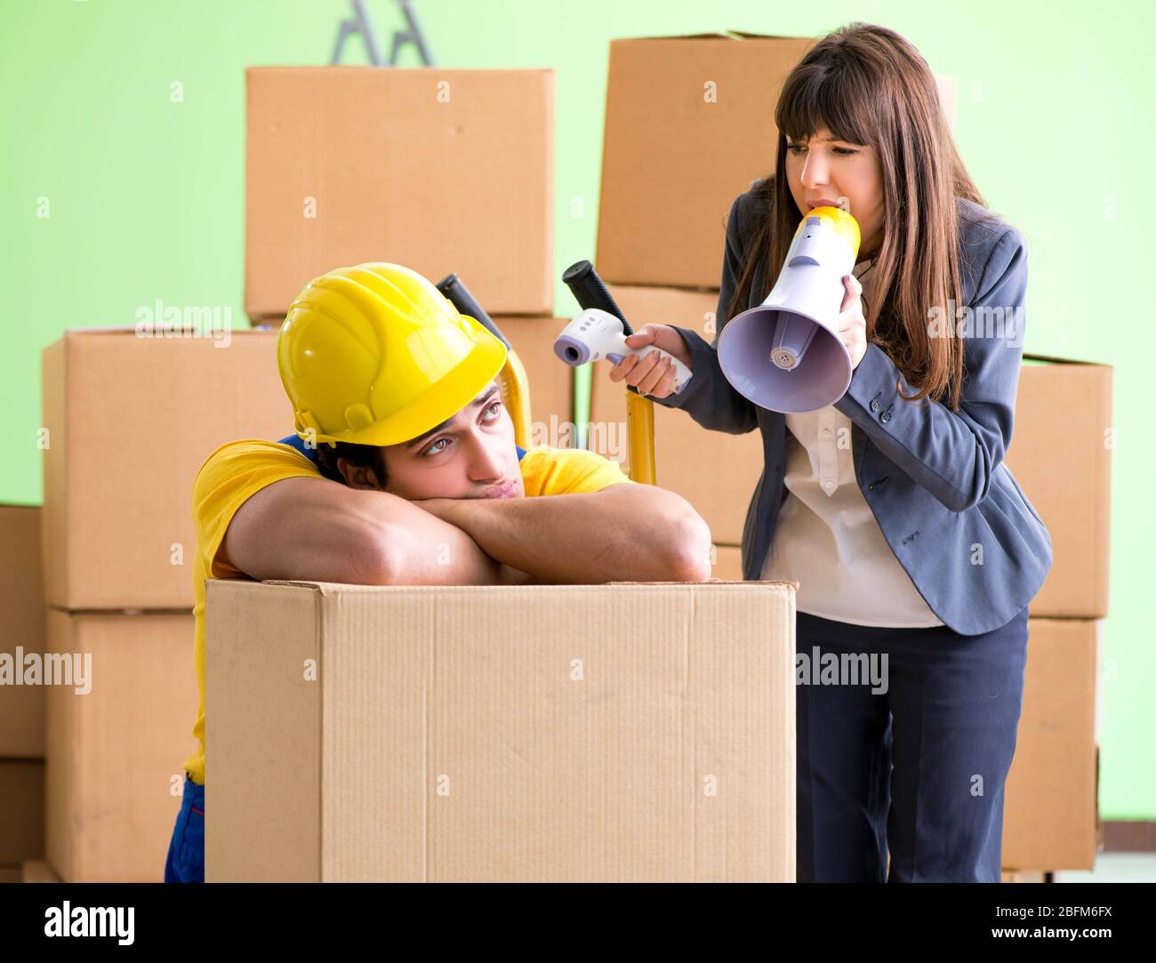 The woman boss and man contractor working with boxes delivery Stock ...