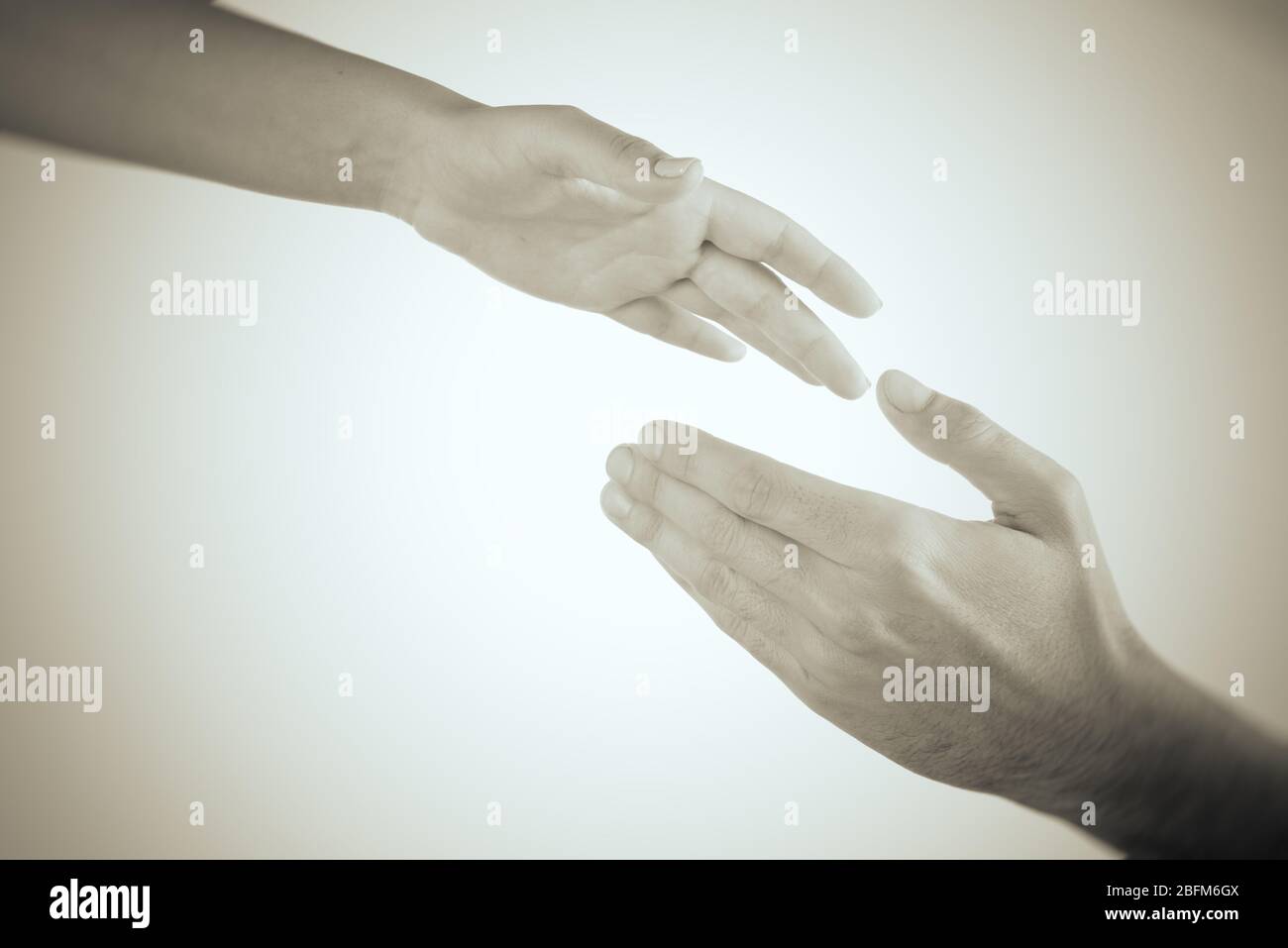 Two hands reaching toward each other. Helping concept. Vintage tone ...