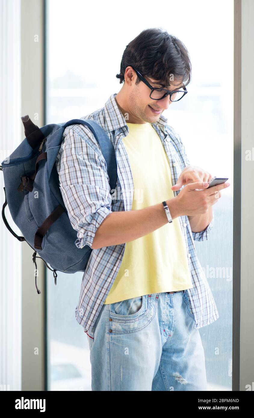 The young handsome student standing at the window Stock Photo - Alamy