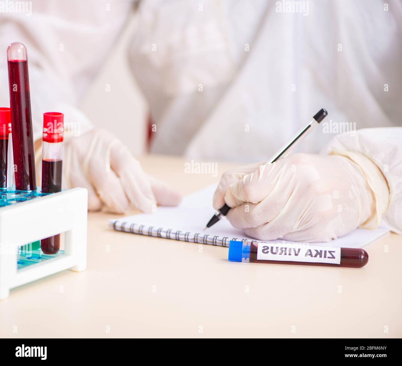 The young handsome lab assistant testing blood samples in hospital ...