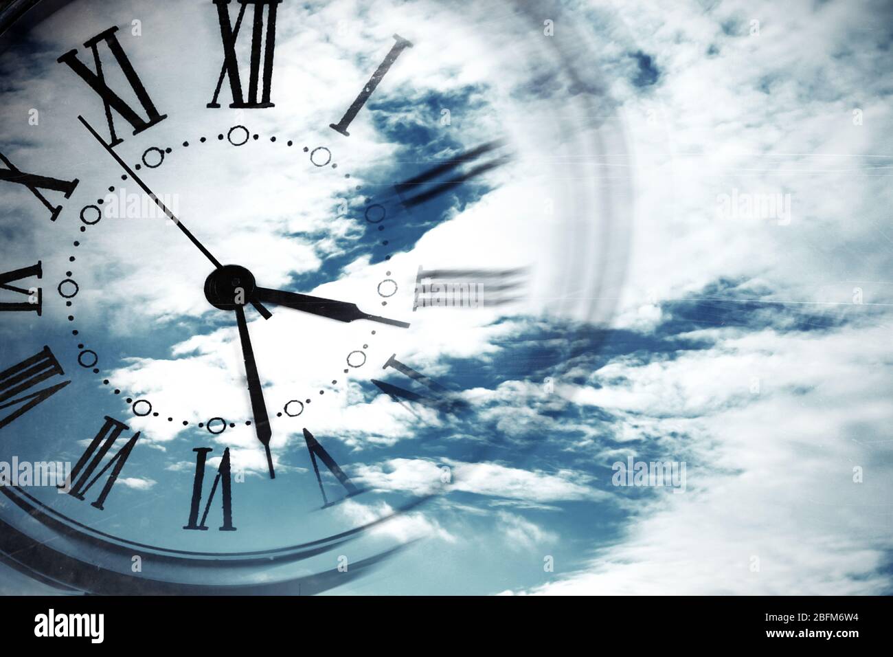 Clock face in bright sky Stock Photo - Alamy