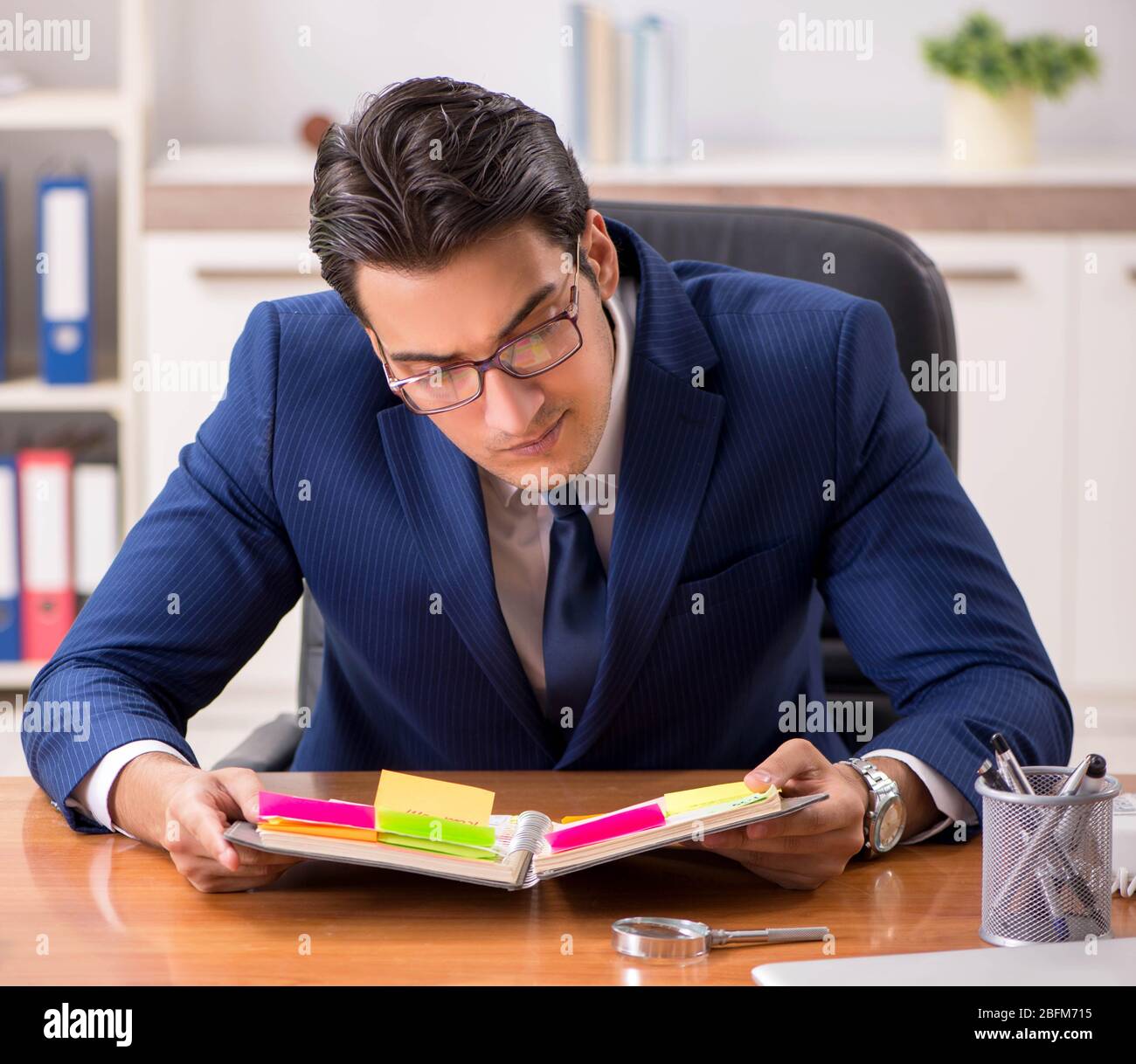 The young handsome employee planning his work activity Stock Photo - Alamy