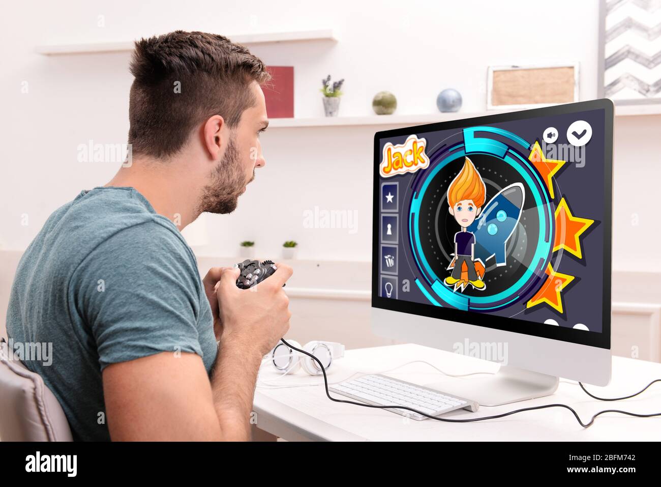 Young man playing computer games at home Stock Photo - Alamy