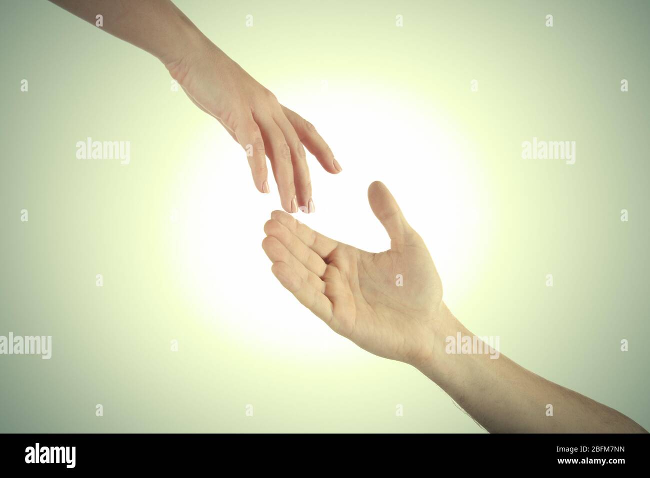 Two hands reaching toward each other. Helping concept. Vintage tone ...