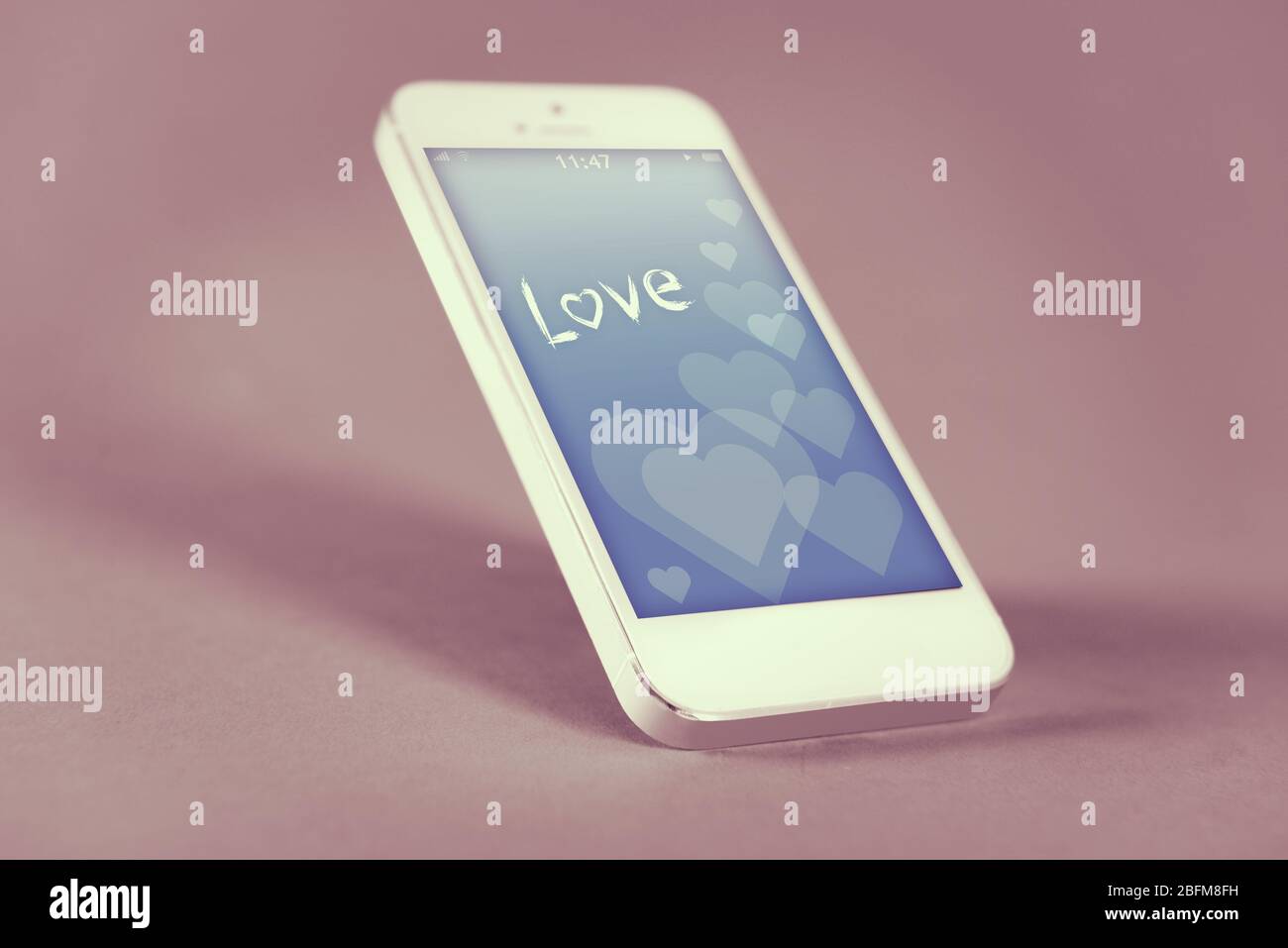 Modern touchscreen mobile phone with romantic screensaver Stock Photo ...