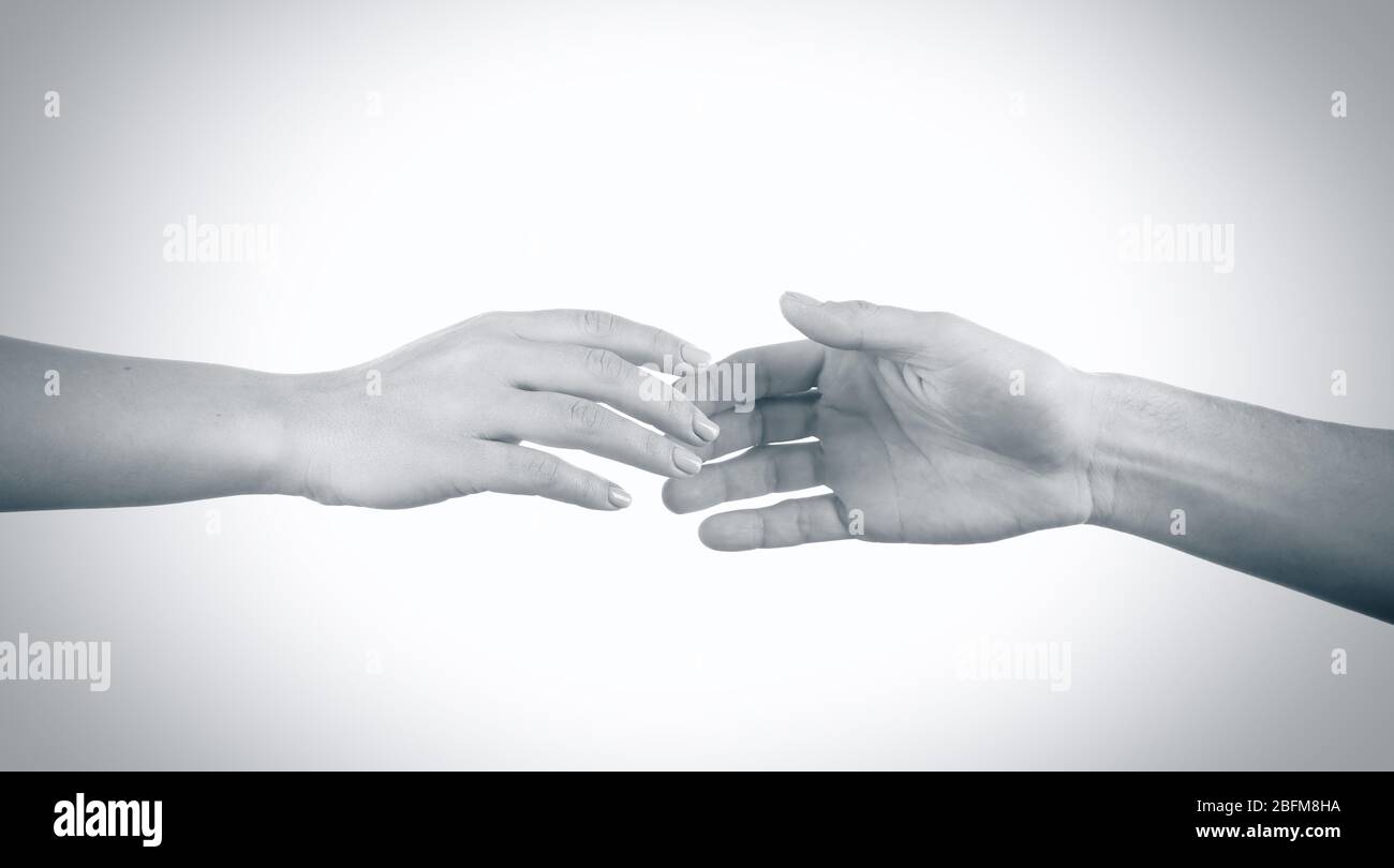 Two hands reaching toward each other. Helping concept. Vintage tone ...