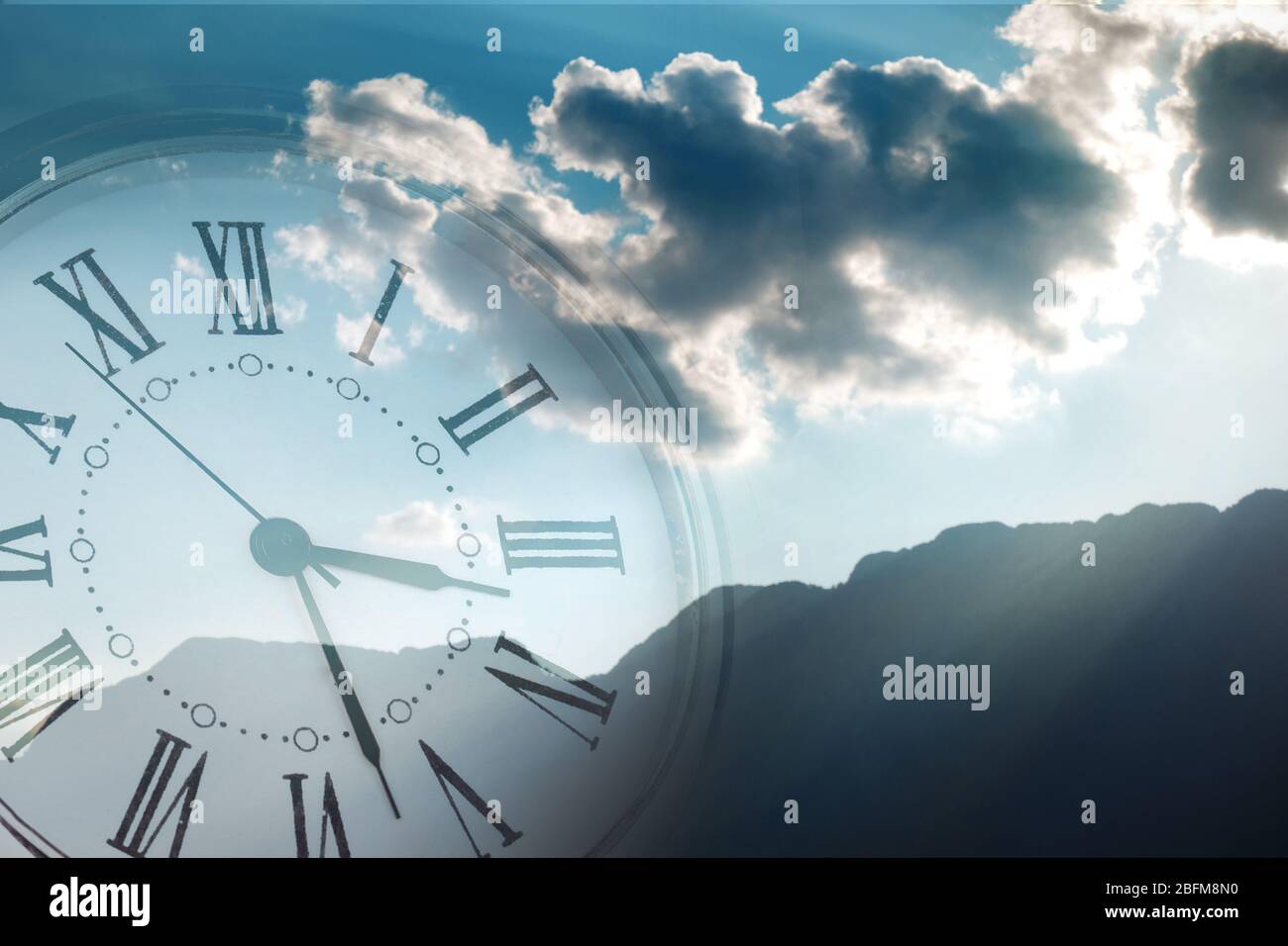 Clock face in bright sky Stock Photo - Alamy