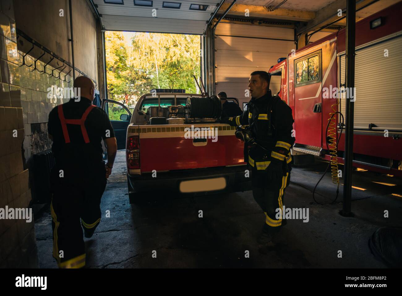 Fire engine truck parked inside the garage of the fire department Stock ...