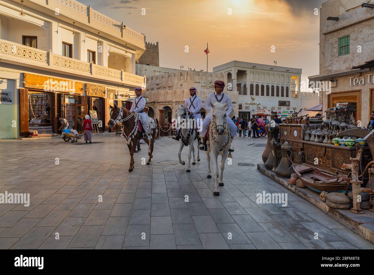 Souk Waqif Doha, Qatar main street daylight view with traditional police riding horses and ...