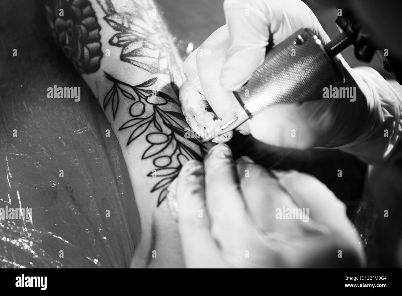 Professional tattoo artist doing tattoo, close up Stock Photo - Alamy