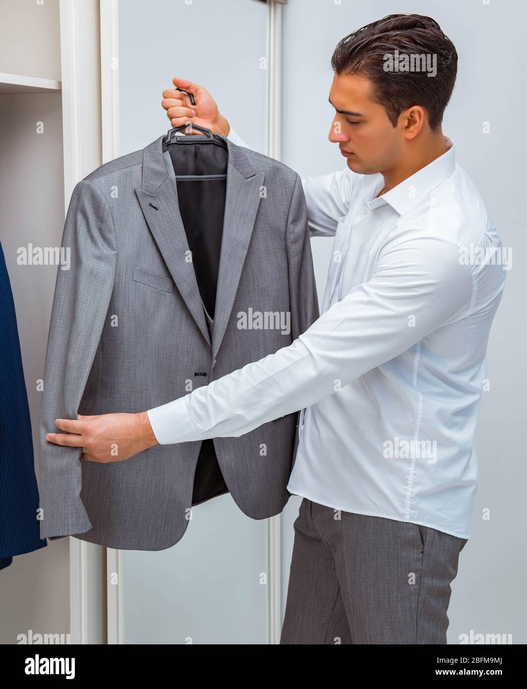 The businessman dressing up for work Stock Photo - Alamy