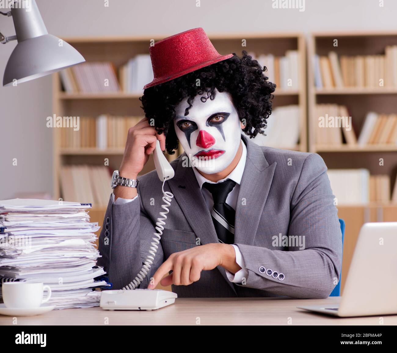 The clown businessman working in the office Stock Photo - Alamy