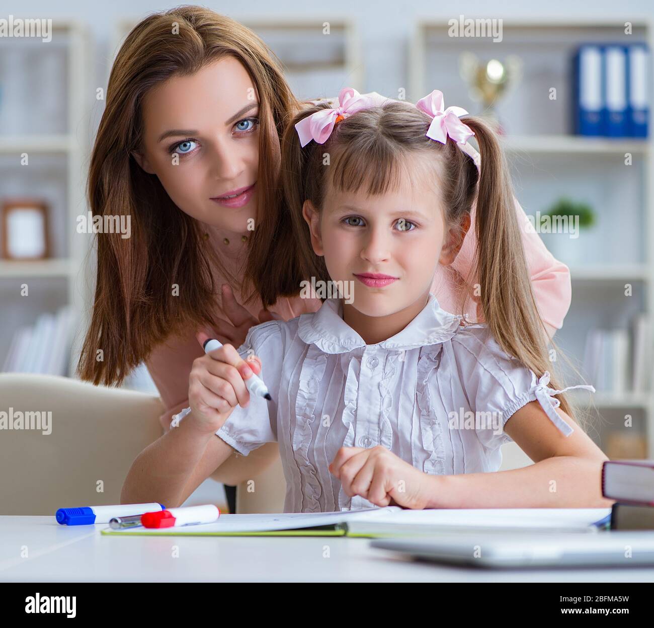 The mother helping her daughter to do homework Stock Photo - Alamy