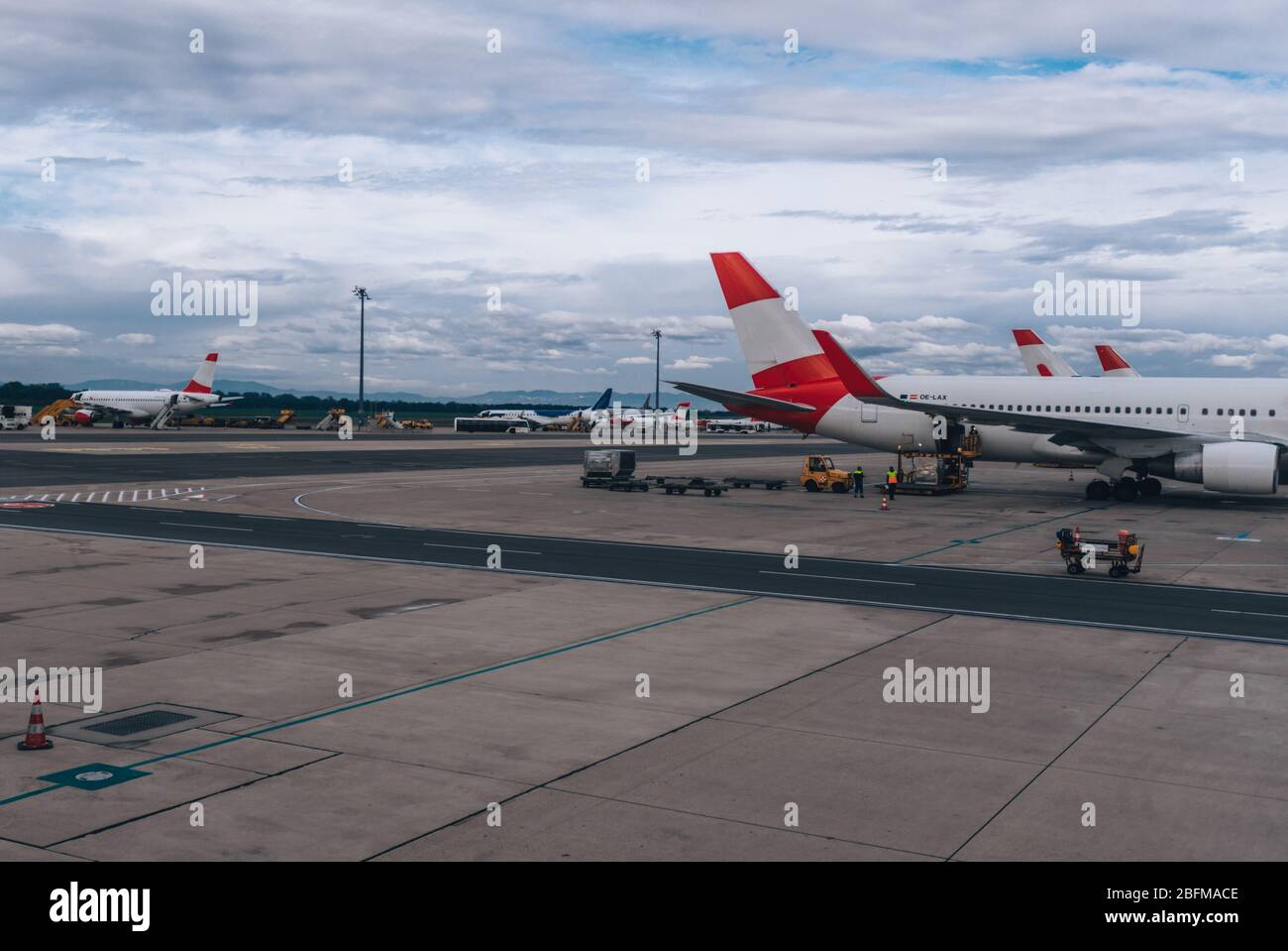 Multiple airplanes with several support and utility vehicles on an ...