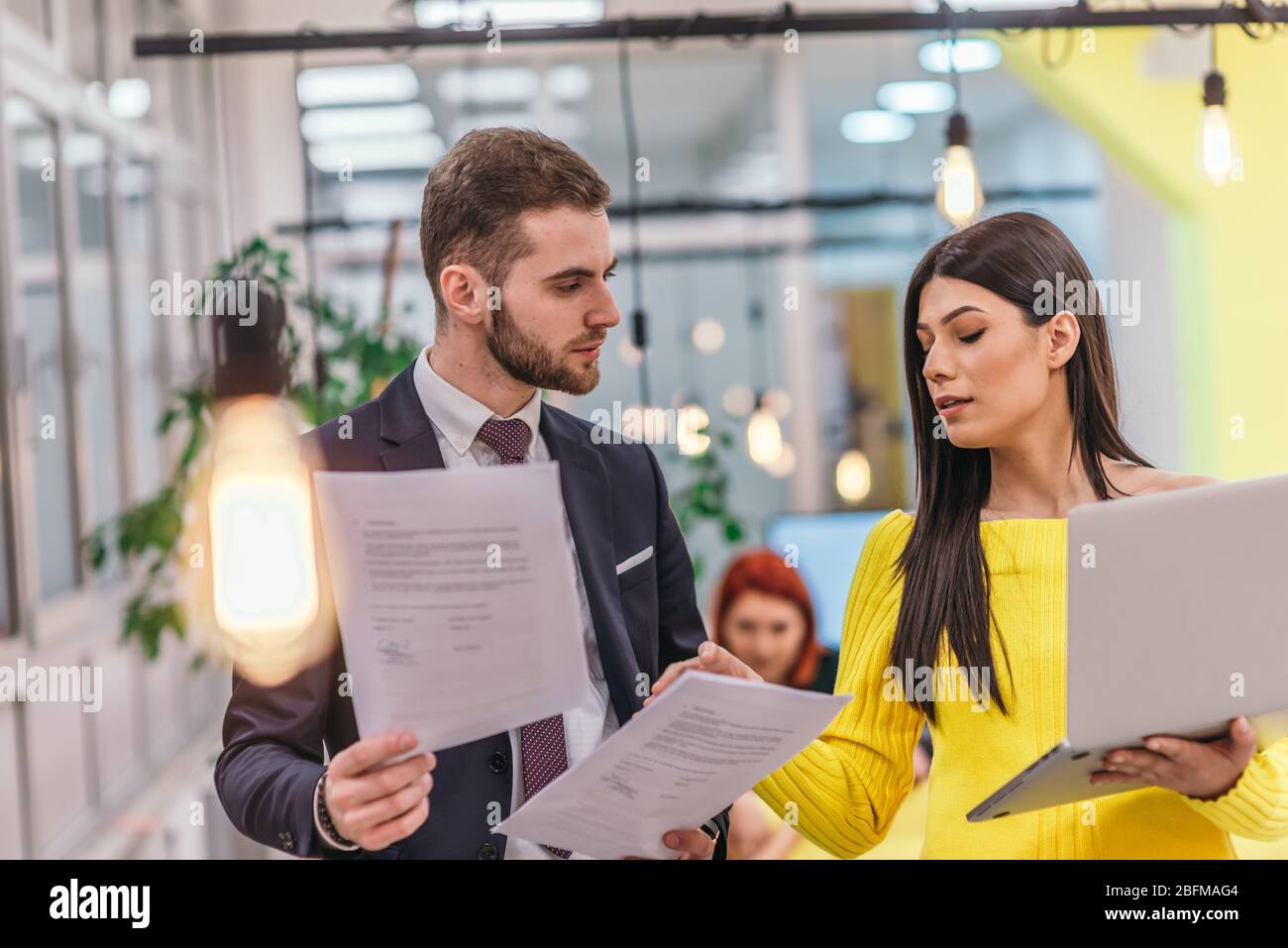 Manager explaining to his employee how to finish her tasks. Colleagues ...