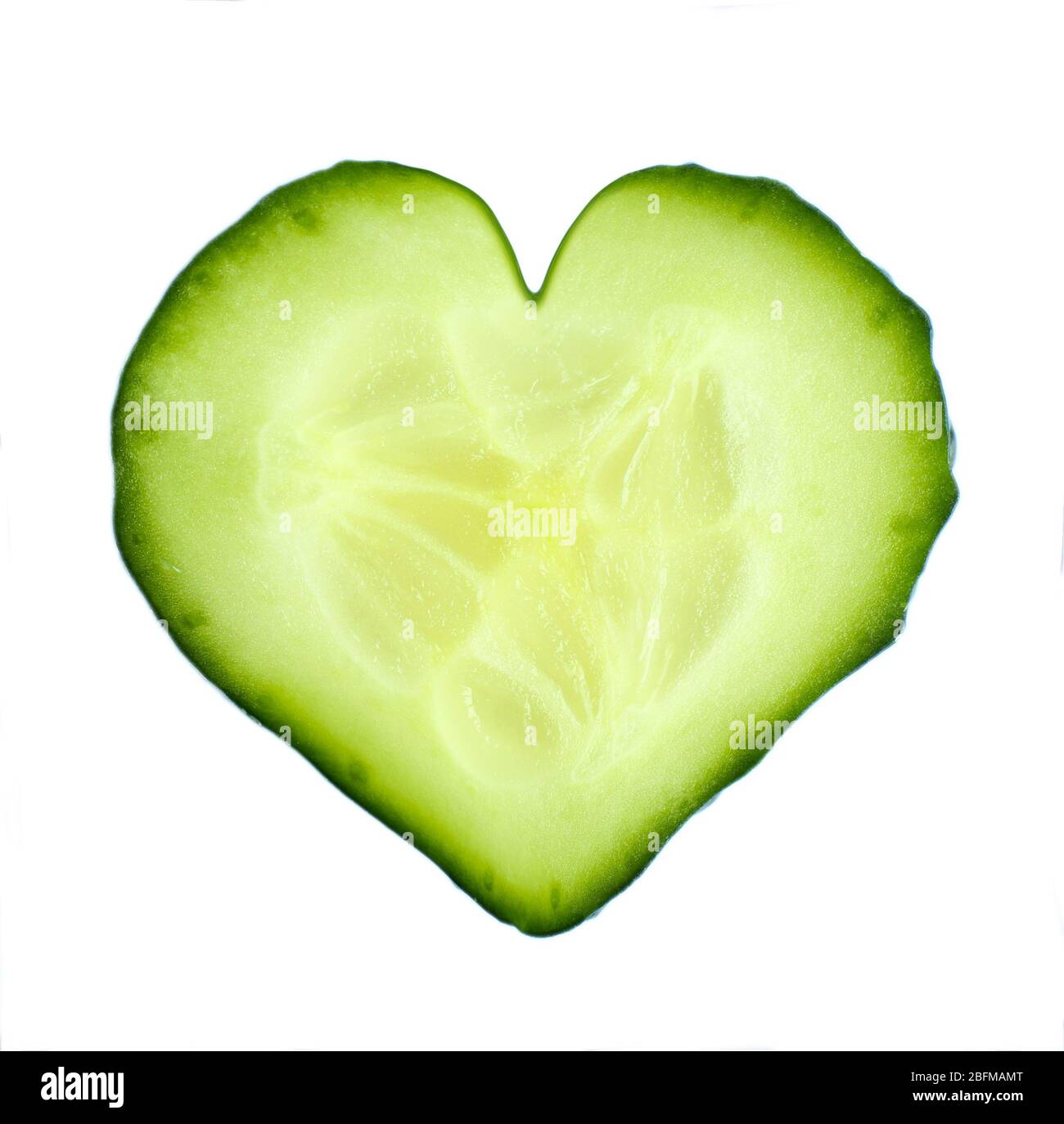 Slice of fresh cucumber in heart shape, isolated on white Stock Photo ...