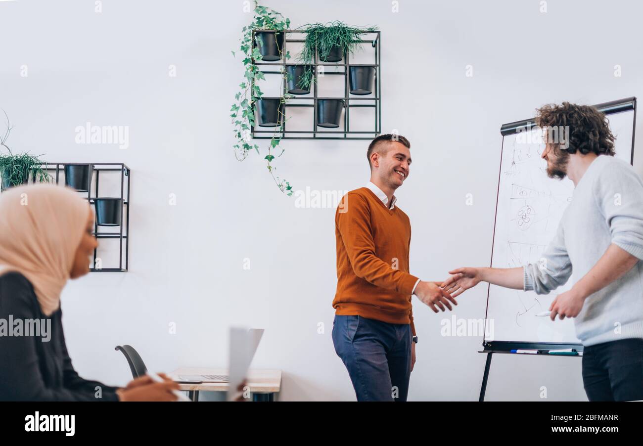 Group of coworkers having a business plan discussion at their office ...