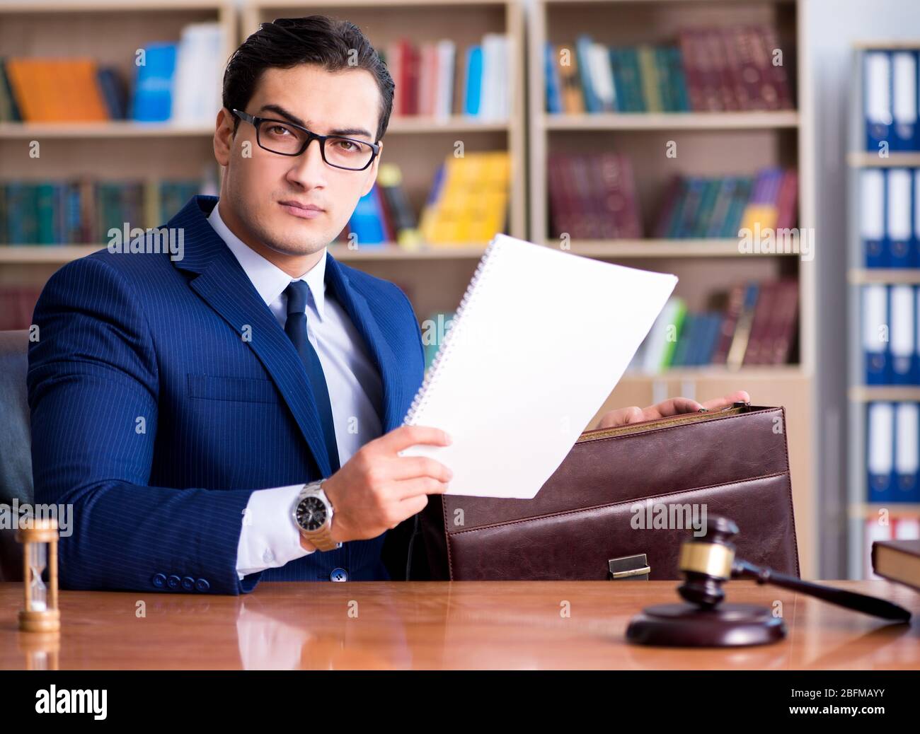 The handsome judge with gavel sitting in courtroom Stock Photo - Alamy