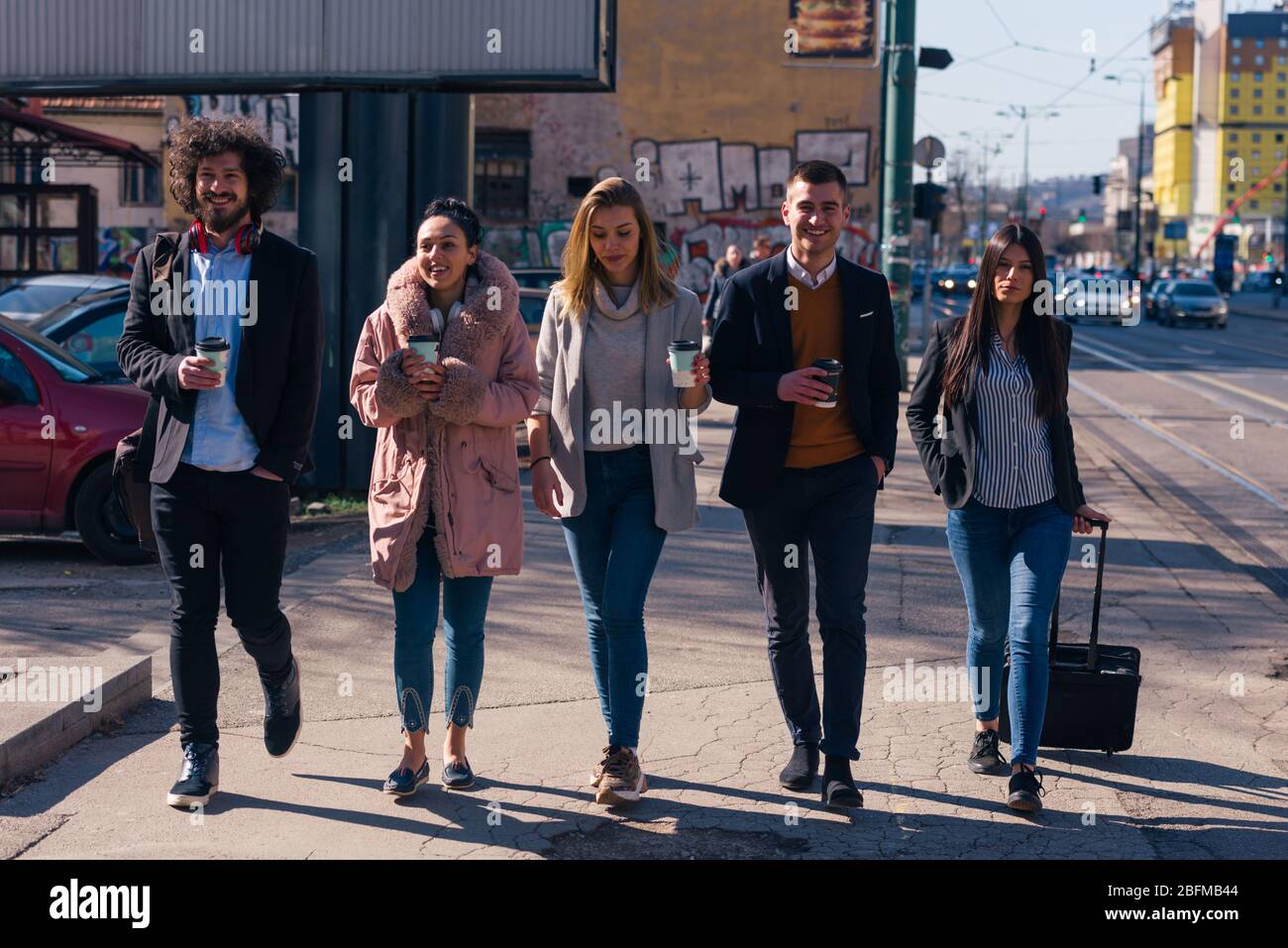 Group of friends (colleagues) hanging out in an urban area Stock Photo ...
