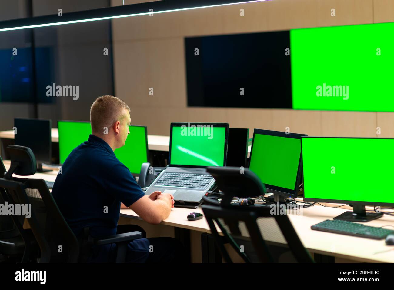 Male operator watching the cctv monitors Stock Photo - Alamy