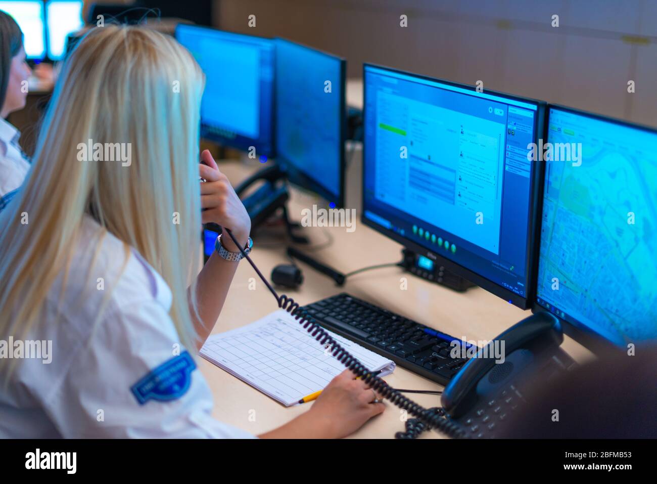 Happy security data center operator colleagues (coworkers) smiling and ...