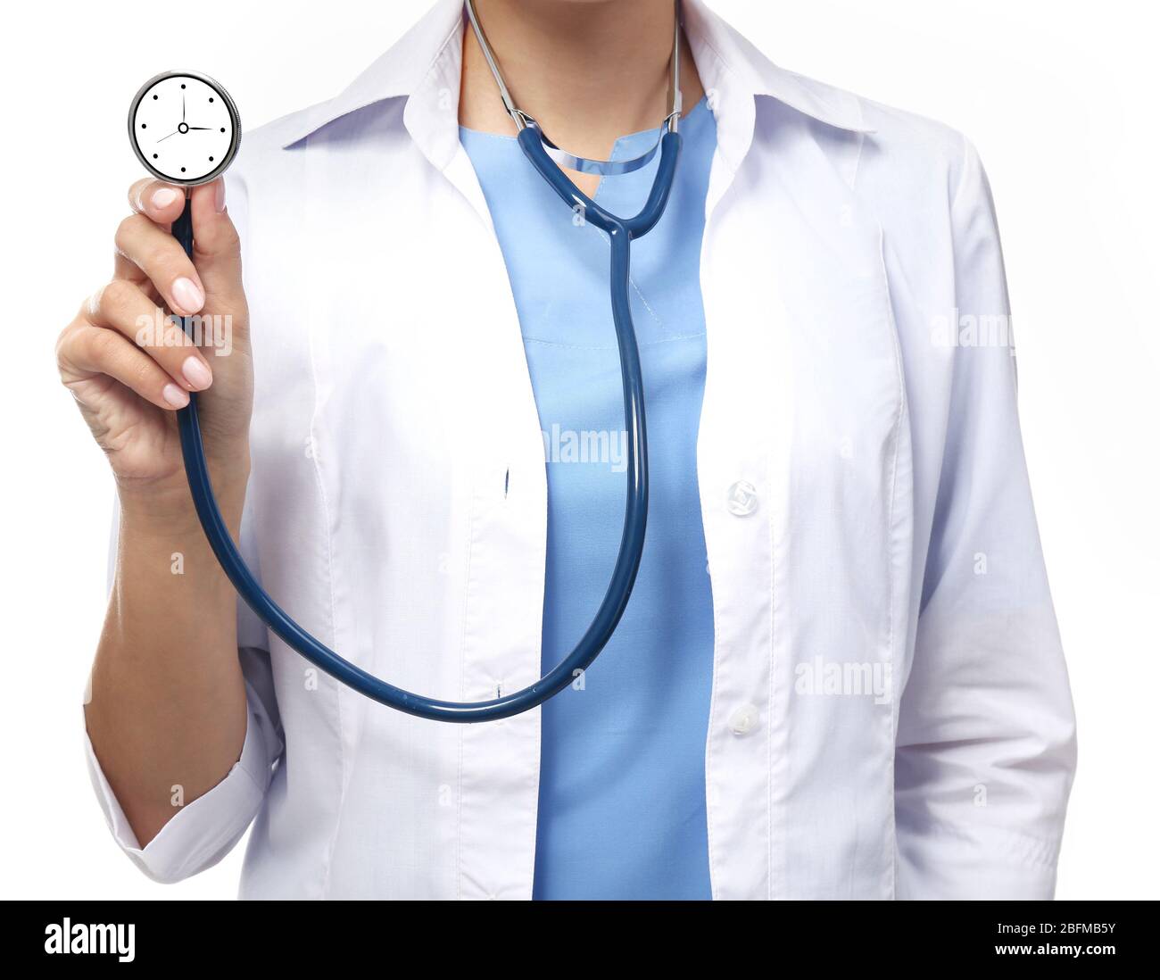 Male doctor holding stethoscope with clock Stock Photo - Alamy