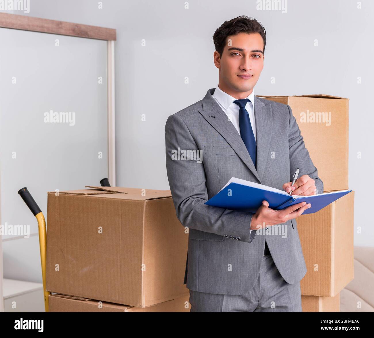 The man signing for the delivery of boxes Stock Photo - Alamy