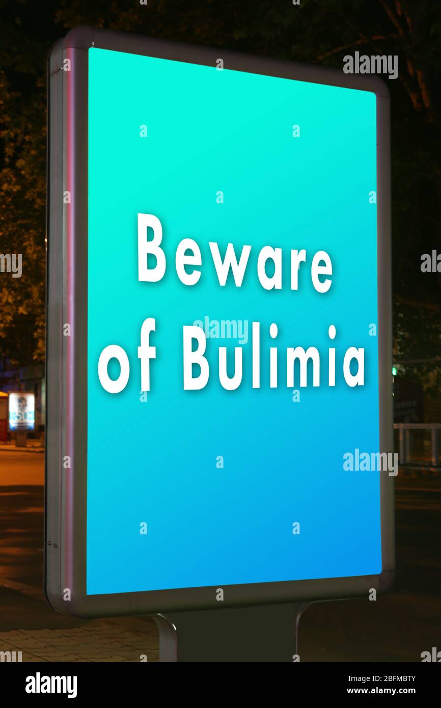 Advertise city-light with text Beware of Bulimia Stock Photo - Alamy