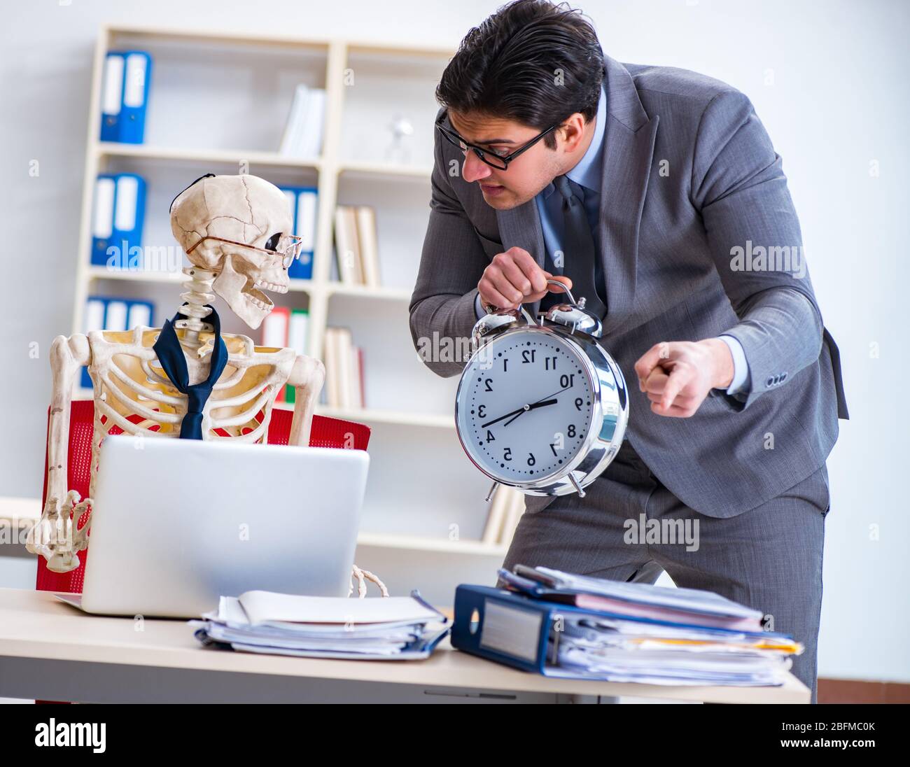 The angry boss yelling at his skeleton employee Stock Photo - Alamy
