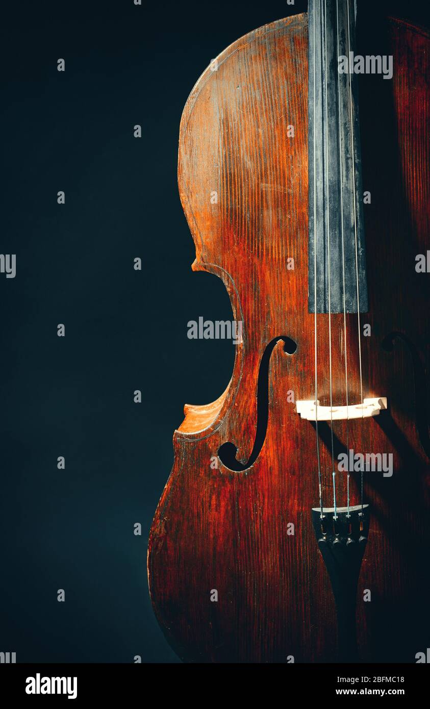 Vintage cello on dark background Stock Photo - Alamy