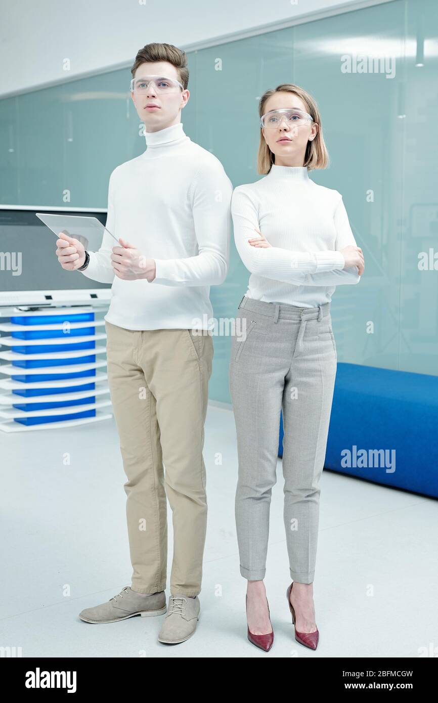 Young elegant managers of futuristic technologies office or center in ...