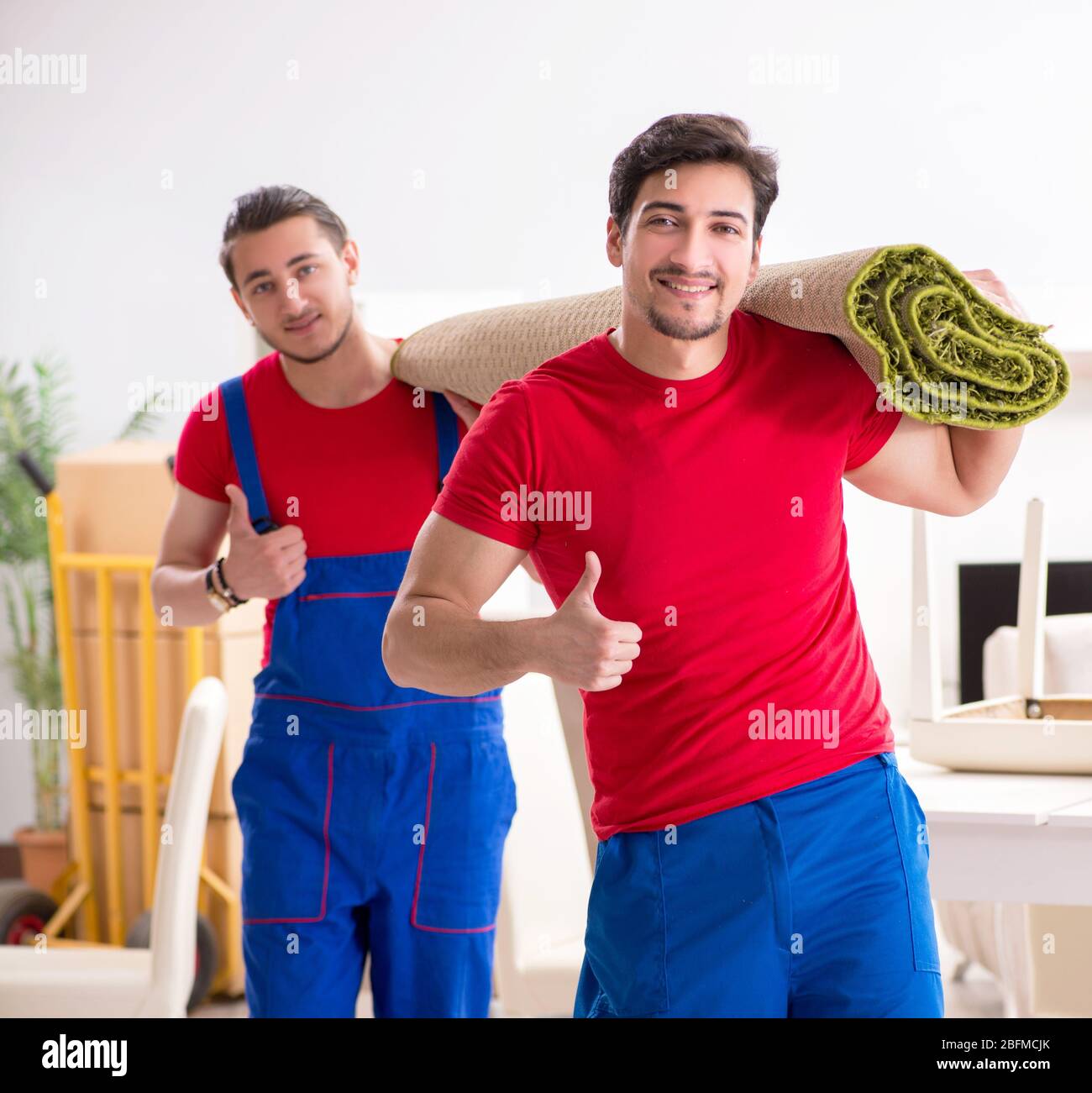 The two contractor employees moving personal belongings Stock Photo - Alamy