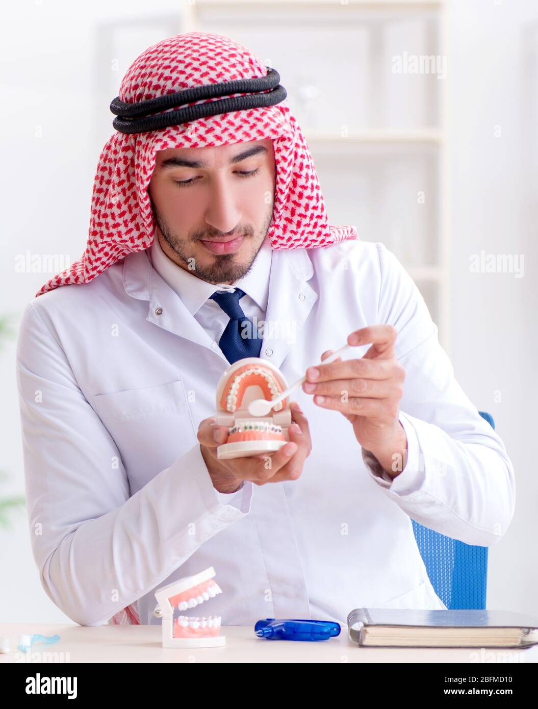 The arab dentist working on new teeth implant Stock Photo - Alamy