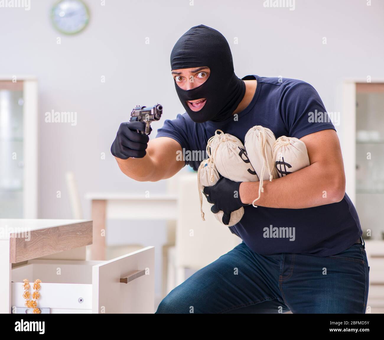 The robber wearing balaclava stealing valuable things Stock Photo - Alamy