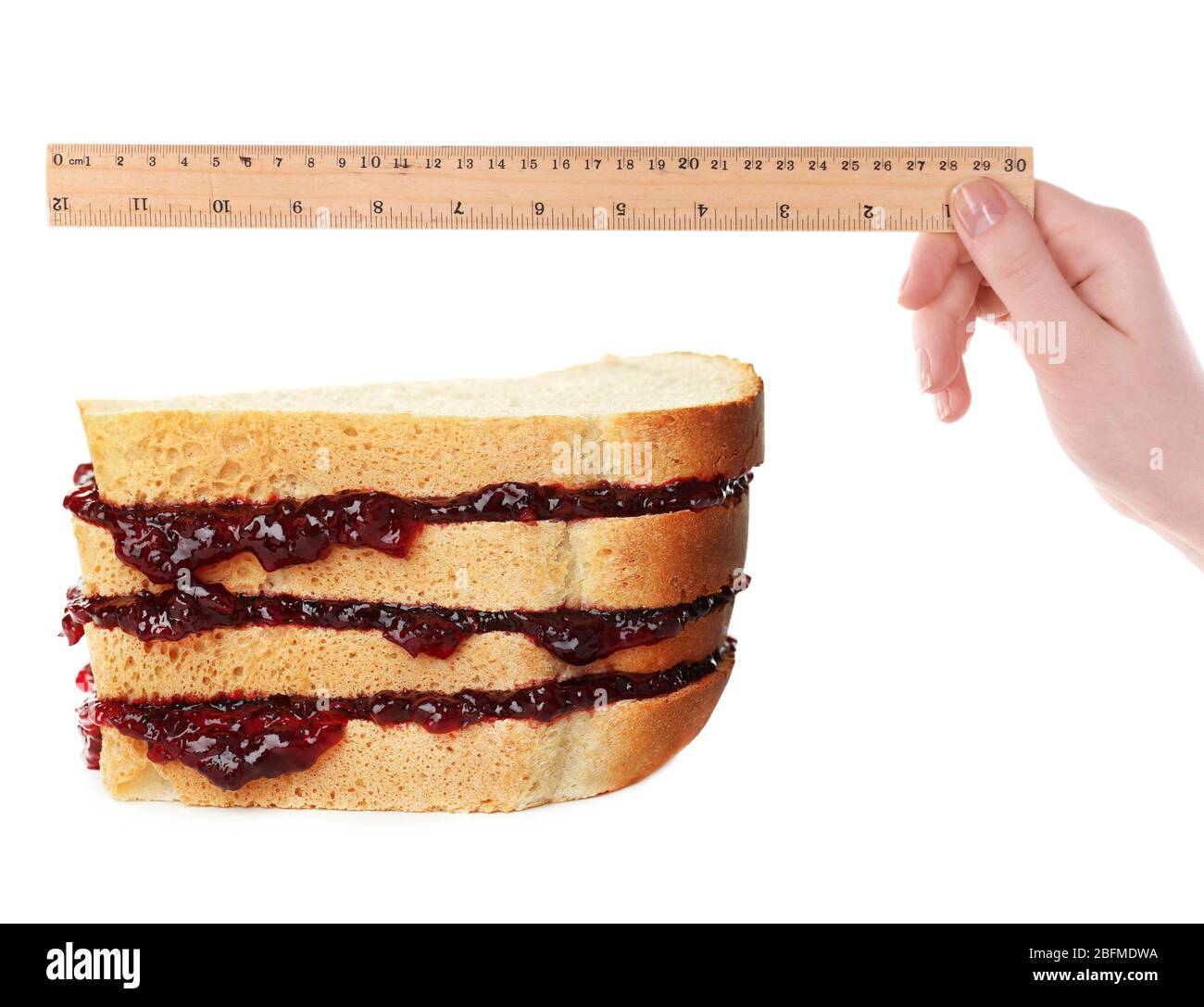 Tasty sandwich with jam and hand with ruler isolated on white Stock ...