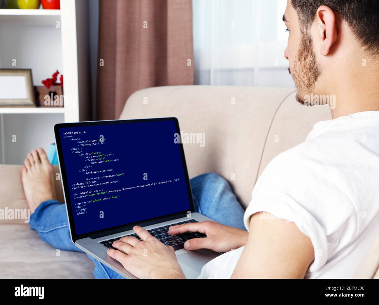 Man using laptop, writing programming code on laptop Stock Photo - Alamy