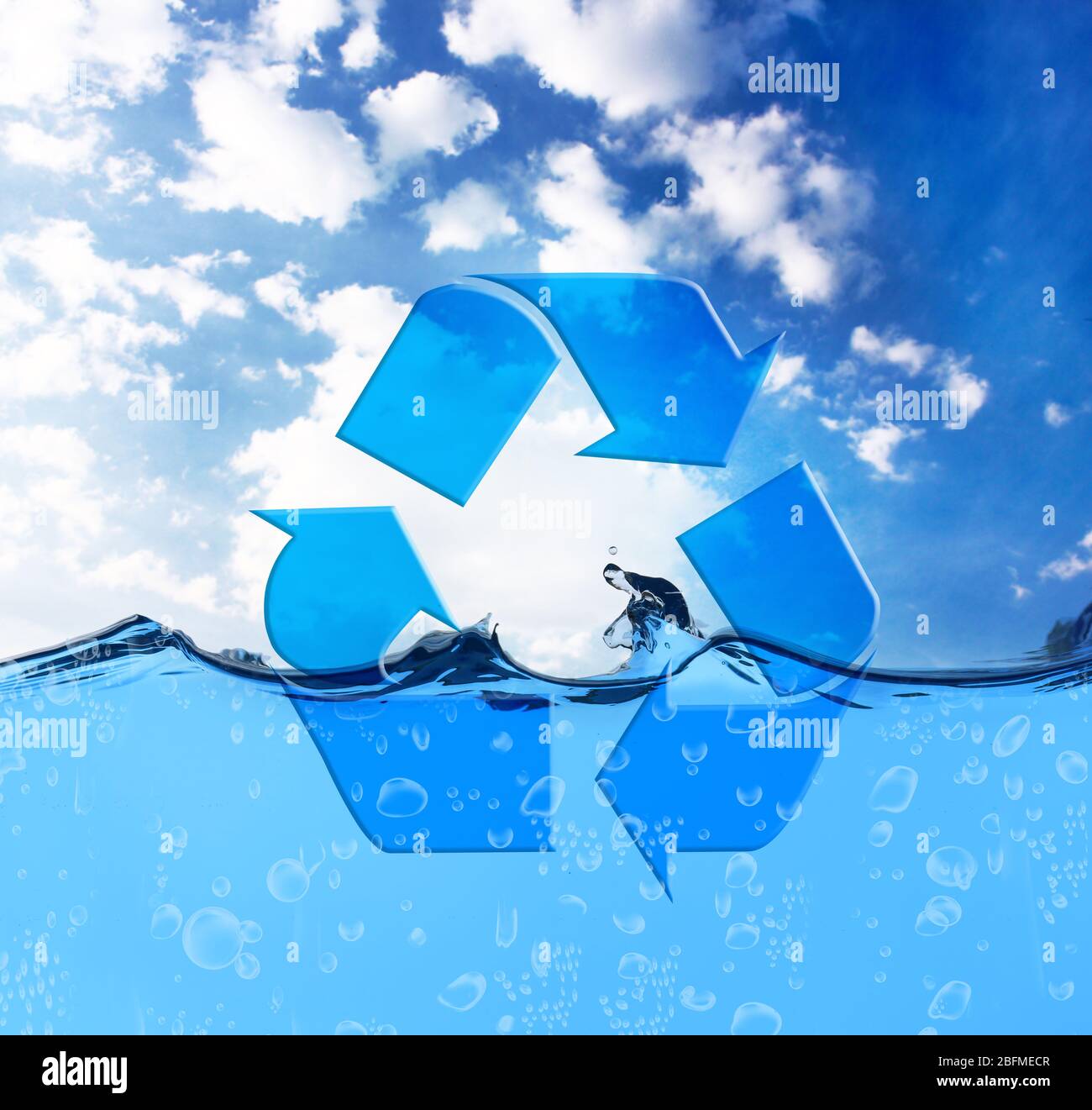 Recycling symbol in water and on cloudy sky background Stock Photo - Alamy