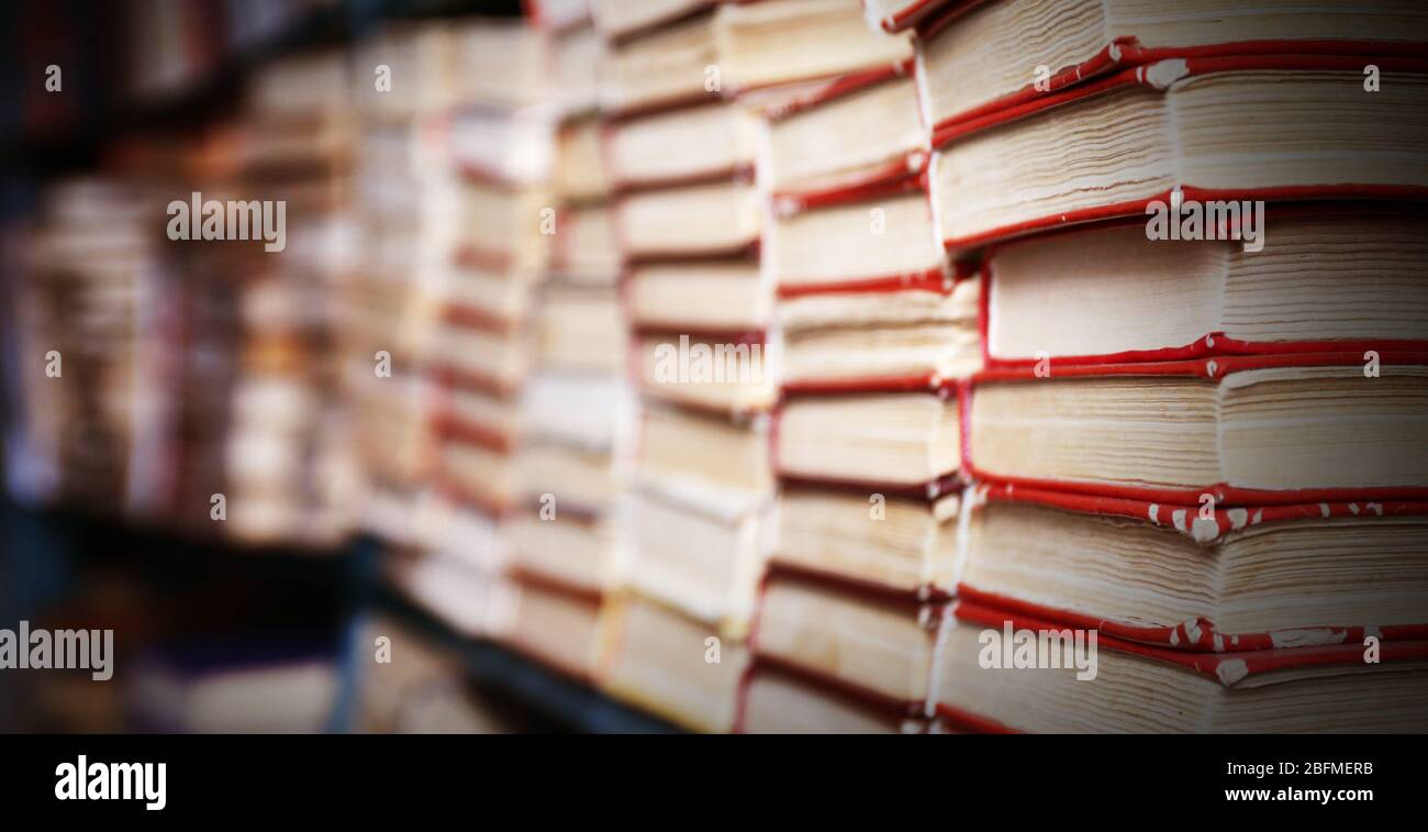 Many books on bookshelf in library, image with perspective distortion ...