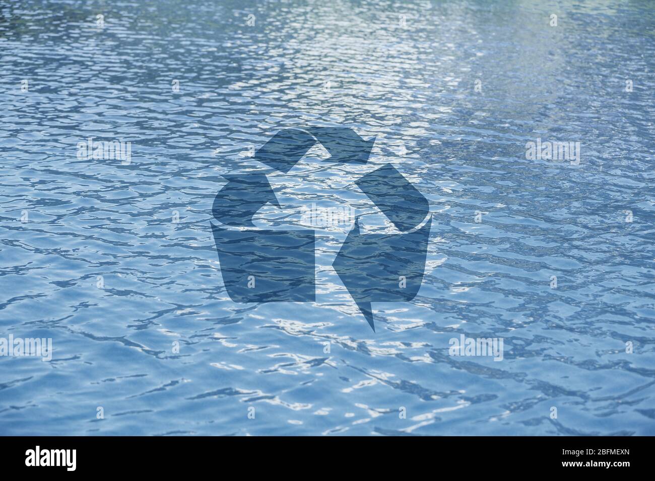 Recycling symbol on water background Stock Photo - Alamy