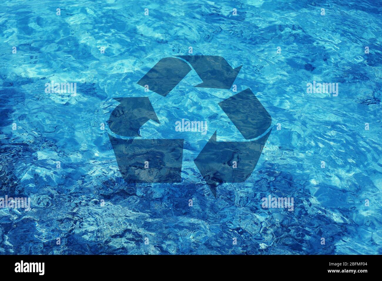 Recycling symbol on water background Stock Photo - Alamy