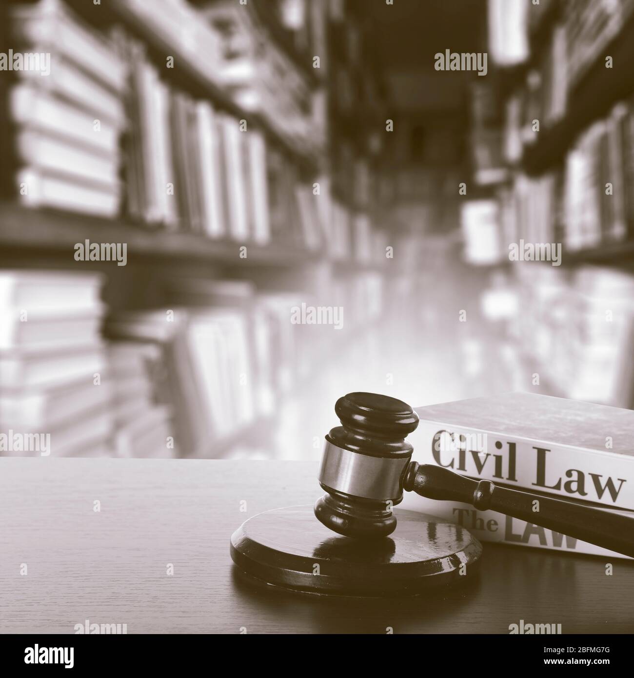 Wooden judges gavel on table in library Stock Photo - Alamy