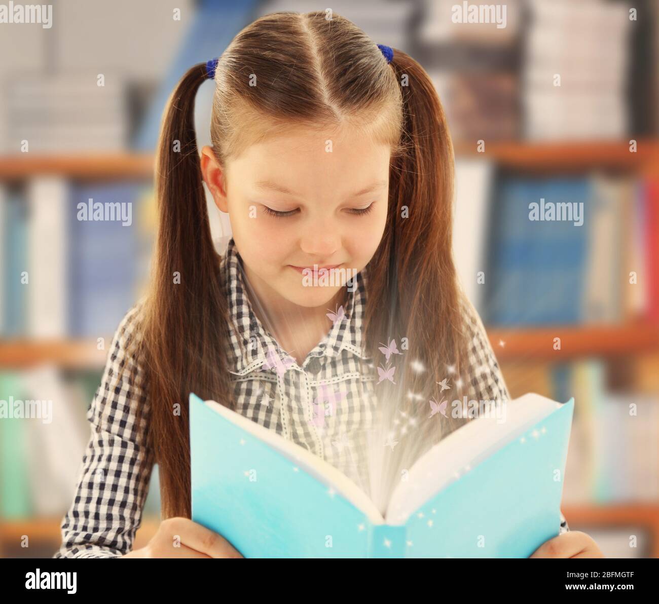Child with magic book Stock Photo - Alamy