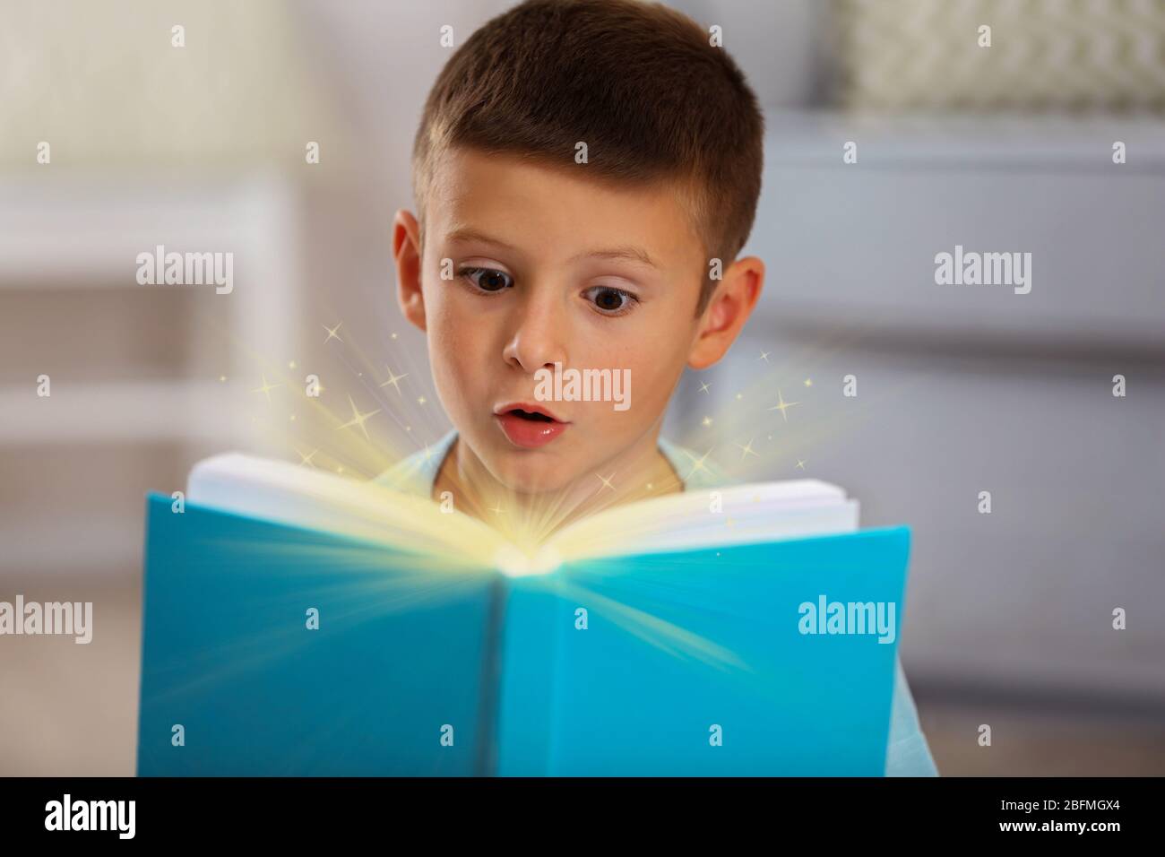 Child with magic book Stock Photo - Alamy
