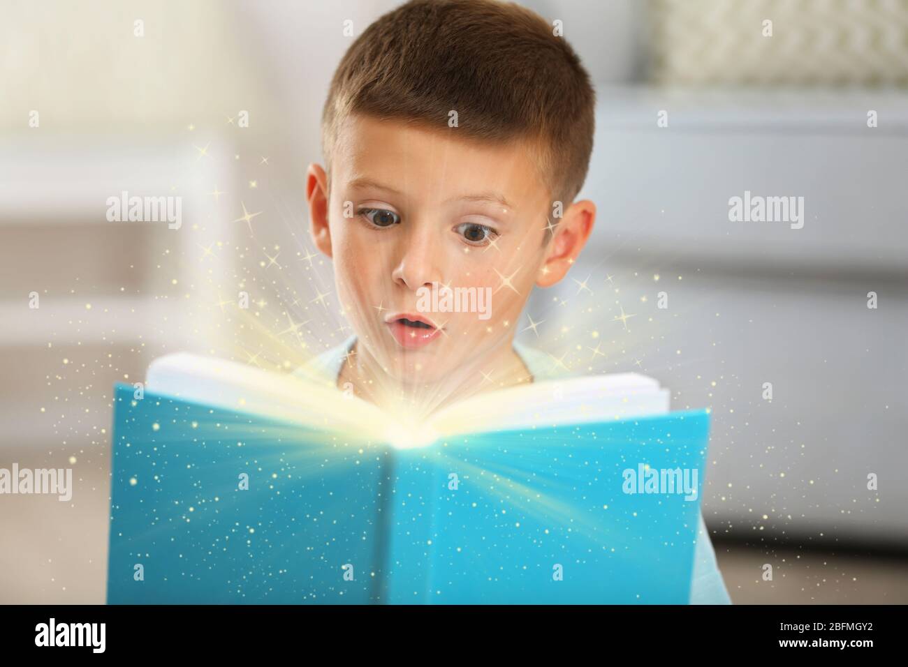 Child with magic book Stock Photo - Alamy