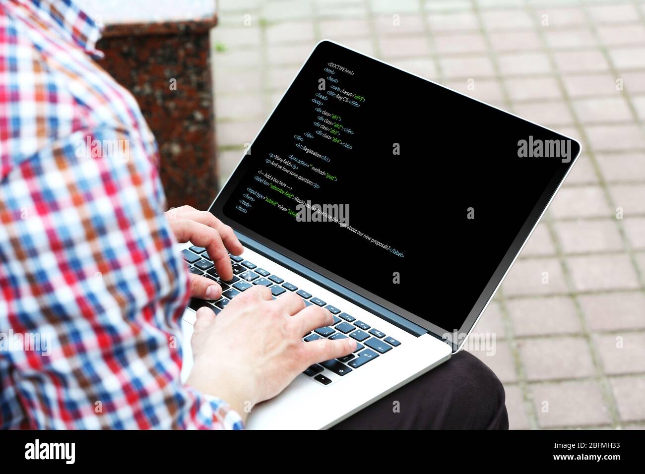Man using laptop, writing programming code on laptop Stock Photo - Alamy
