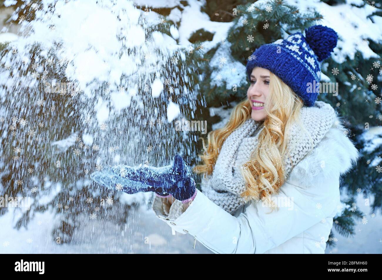 Winter portrait of young beautiful blond woman in her warm clothing in ...