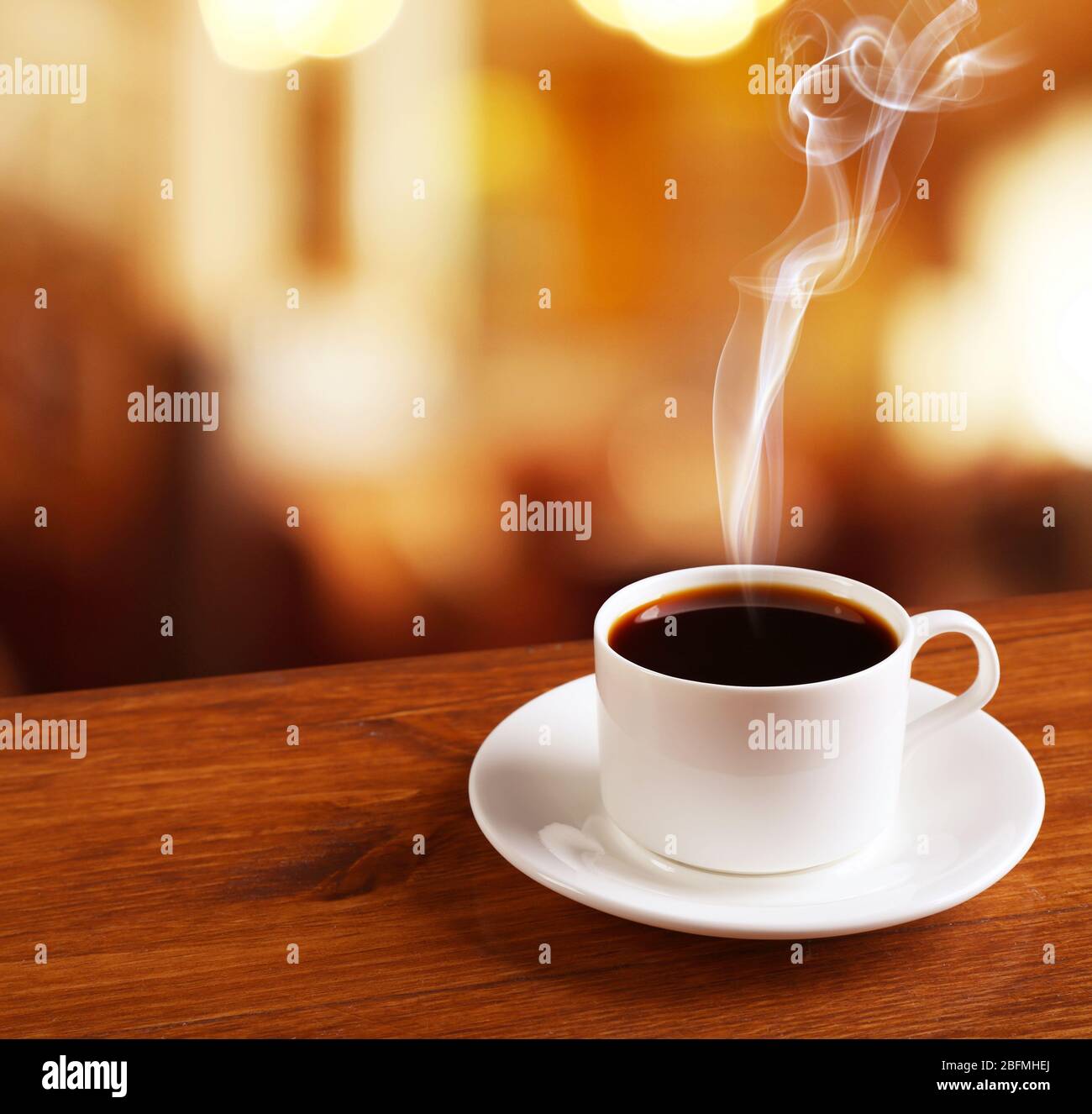 Cup of coffee on table on blured cafe background Stock Photo - Alamy