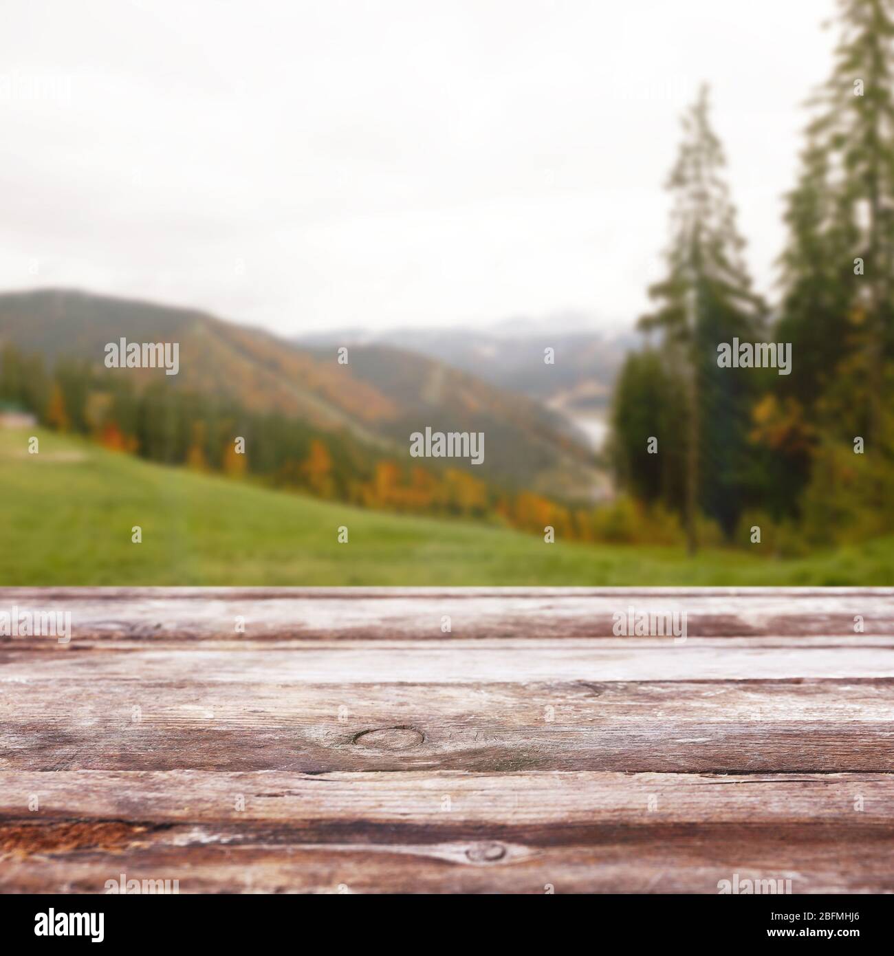 Wooden table on blurred nature background Stock Photo - Alamy