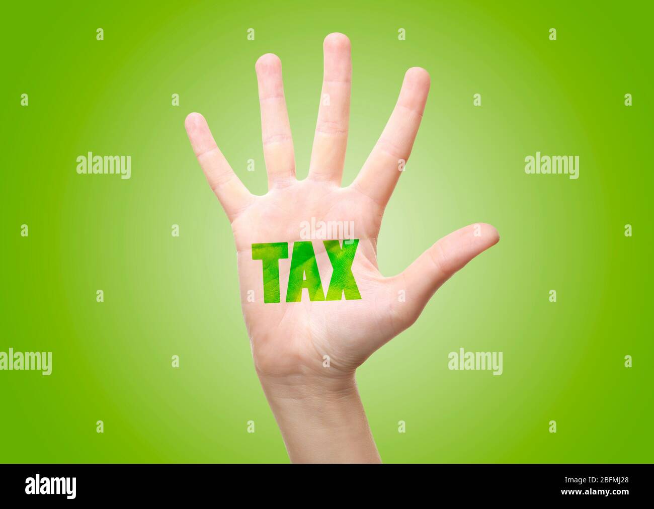 Tax concept. Woman's hand with Tax sign, on green background Stock ...